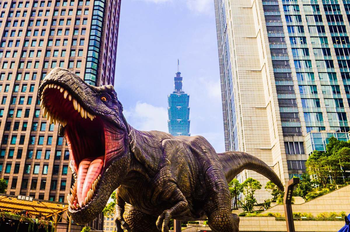 Dinosaur Dinosaur With Open Mouth Beside Buildings Still Selective ... Dinosaur Dinosaur With Open Mouth Beside Buildings Still Selective ...